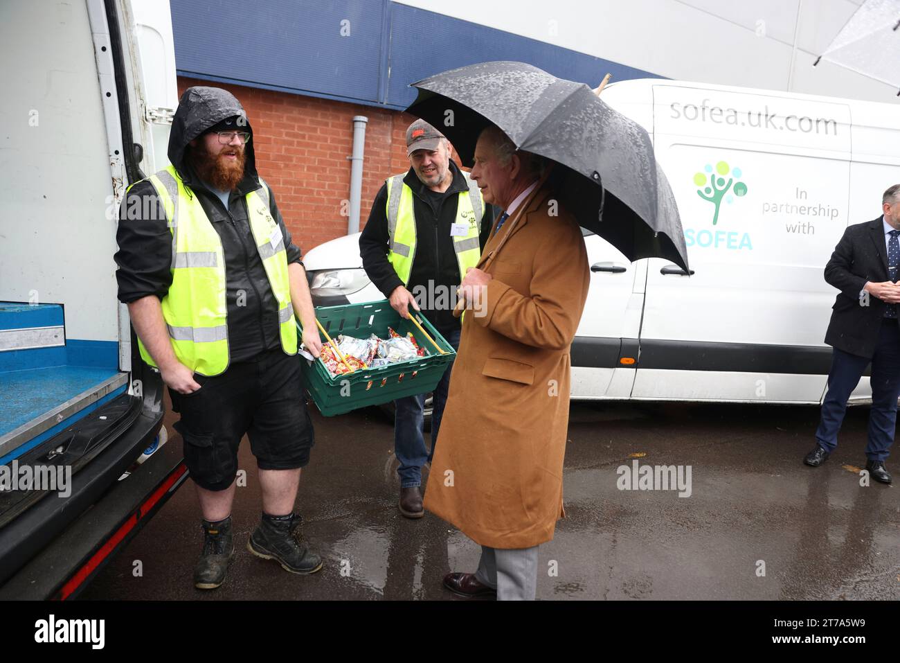 Britain's King Charles III, foreground, meets staff members, during a ...