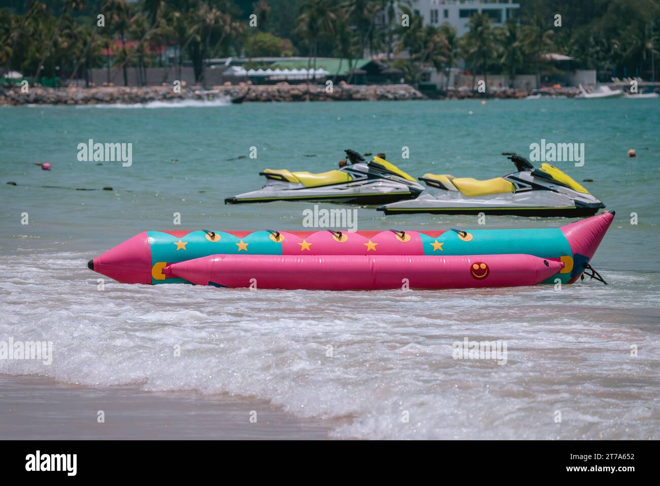 colorful inflatable boats and two jetski for playful beach sport close ...