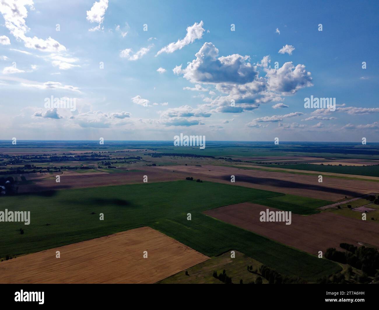Beautiful agricultural landscape, open field with blue sky and white ...