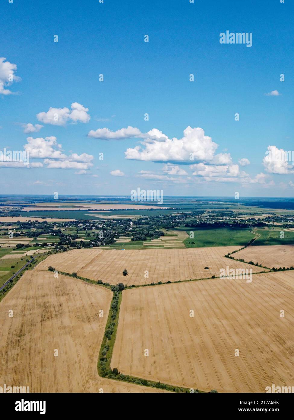 Beautiful agricultural landscape, open field with blue sky and white ...