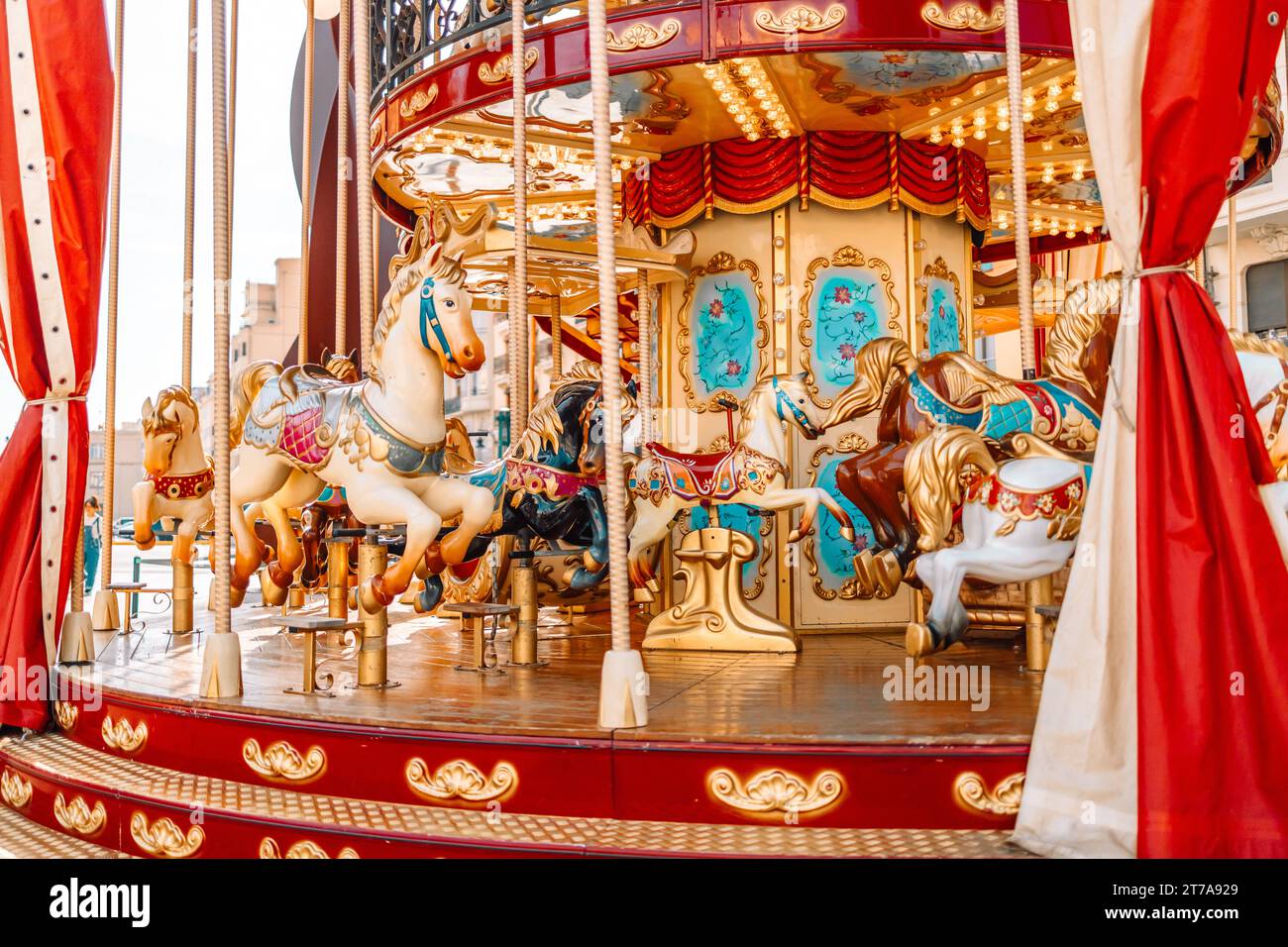 Children’s vintage carousel in the form of horses in a holiday park ...