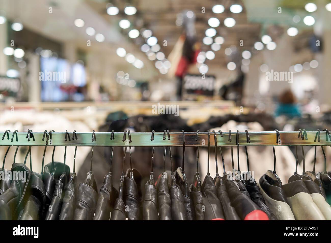 Clothing store inside shopping center, casual clothes, a lot of jackets ...