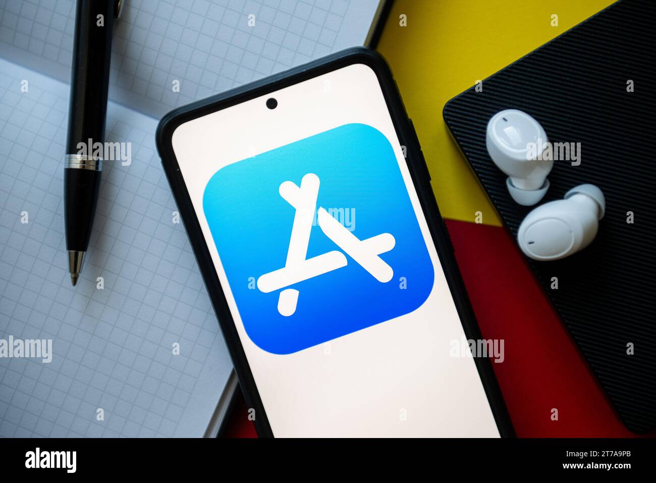 In this photo illustration a Apple app store logo seen displayed on a ...