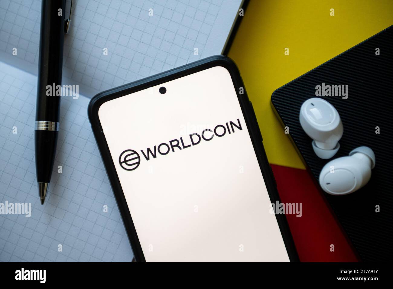 In this photo illustration a Worldcoin logo seen displayed on a ...