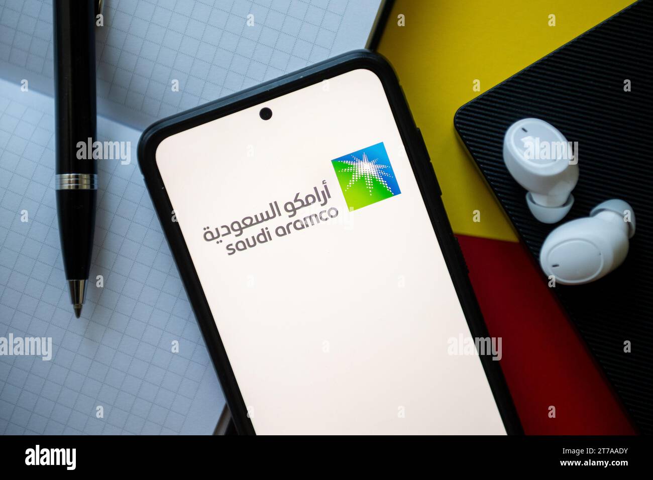 In this photo illustration a Saudi Aramco logo seen displayed on a ...