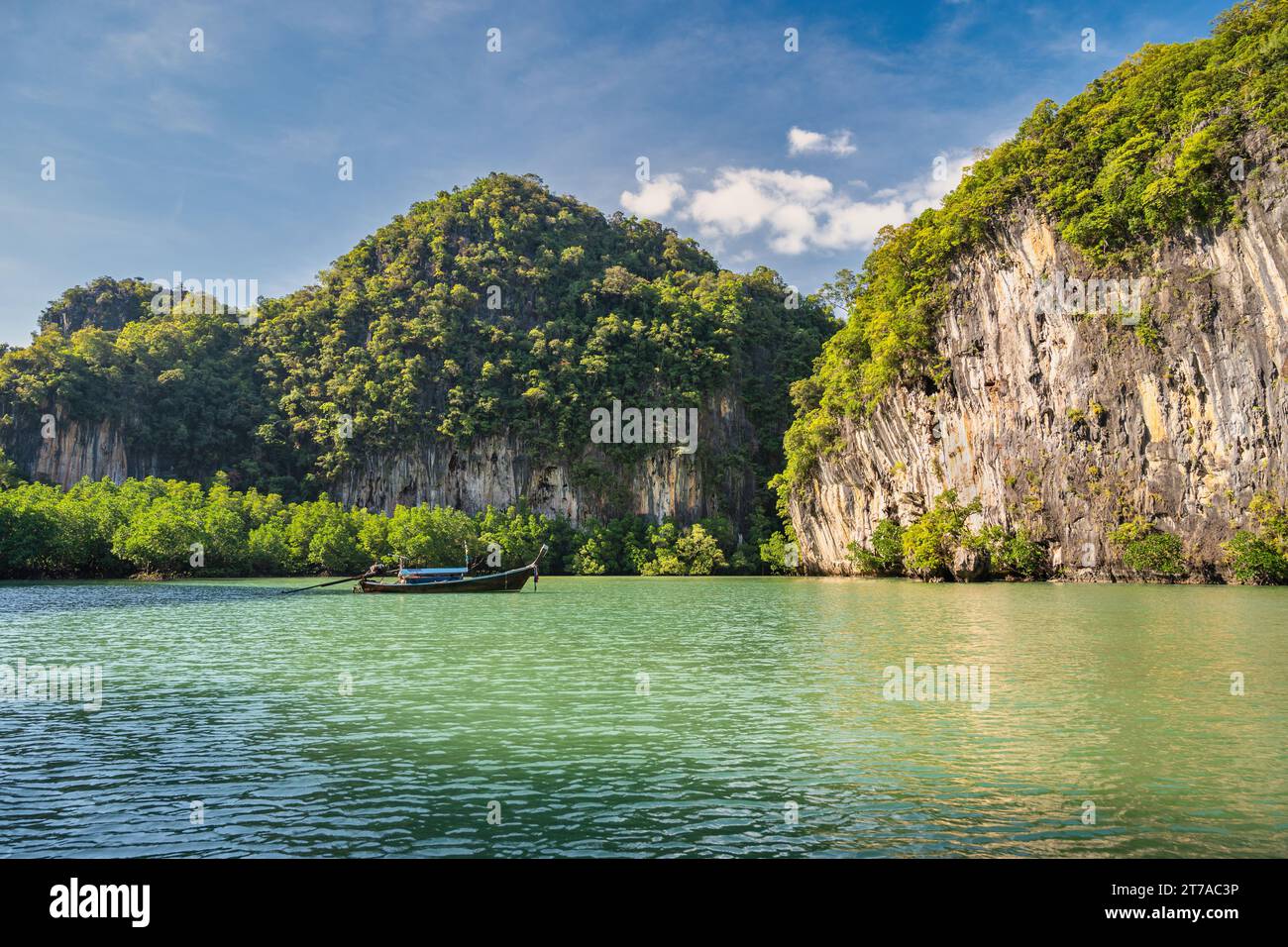 tropical islands view with long tail boat and ocean blue sea water at ...