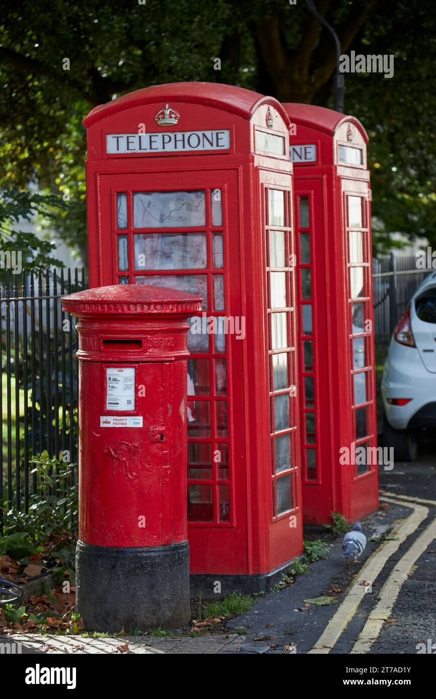 Traditional red Telephone boxes designed by Sir Giles Gilbert Scott and post box in Brighton, UK ...