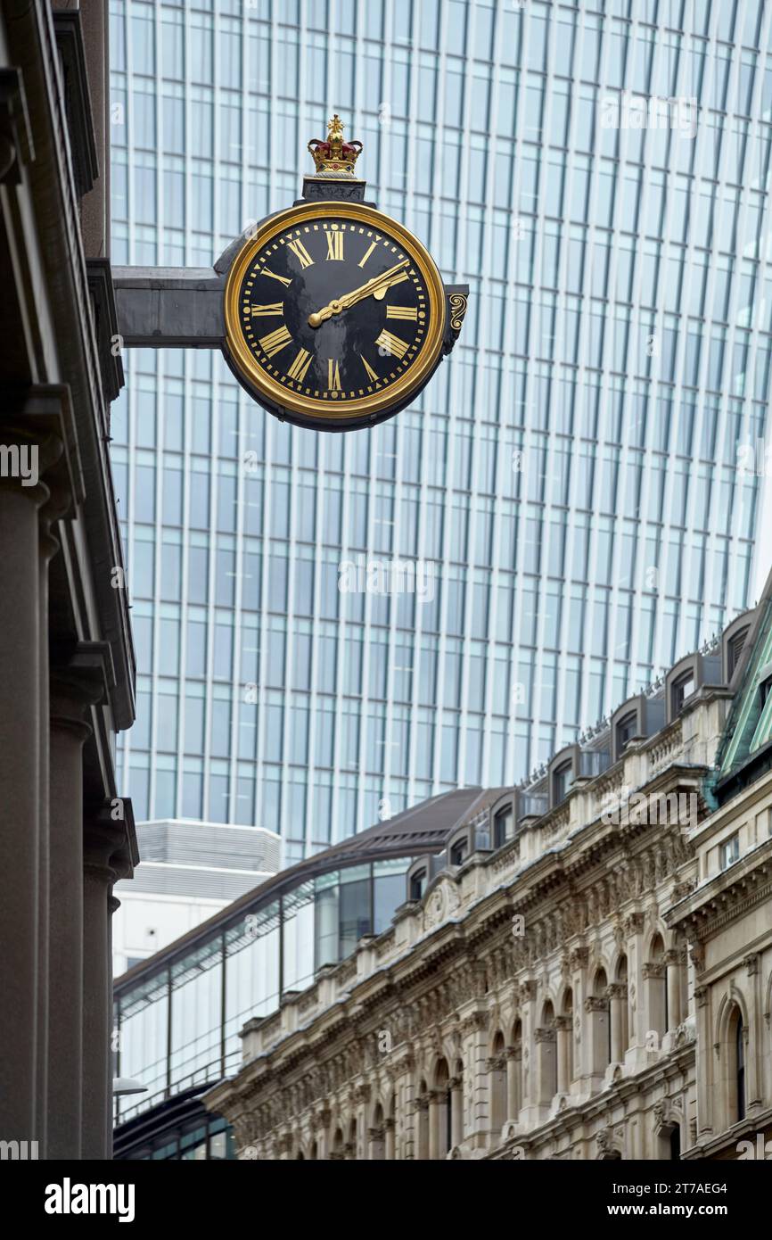 Clock in the City of London with a black dial and gilded Roman numerals ...