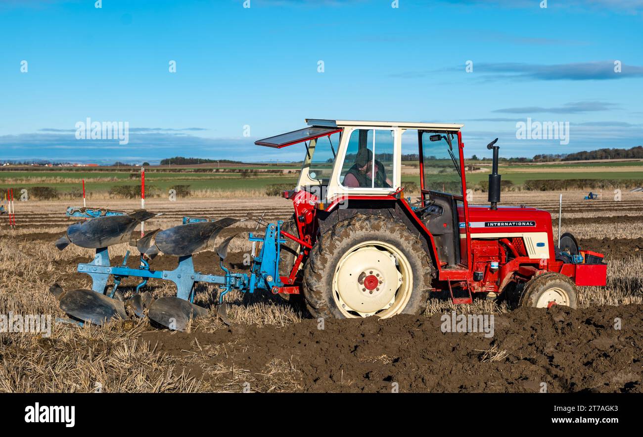 Vintage International tractor ploughing furrows in ploughing match ...