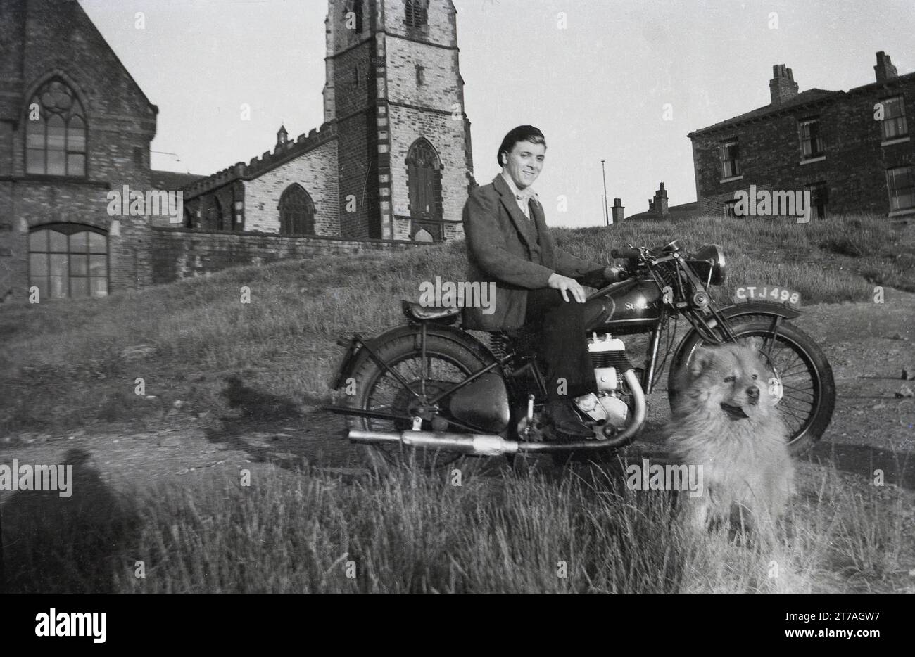 1950s historical, young man with beret sitting on a Sunbeam motorcycle ...