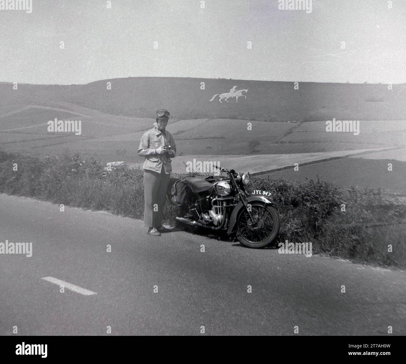 1950s, historical, motorcyce touring, a male rider standing on road ...