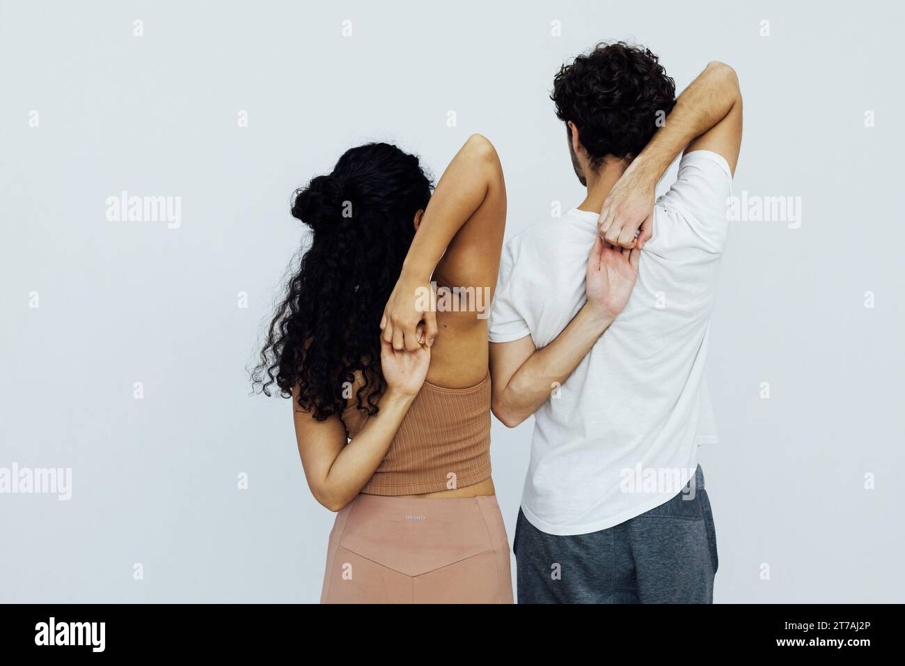 man and woman yoga show hand stretching exercises Stock Photo - Alamy