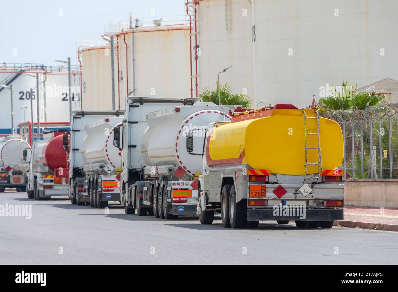 Parking row jam of trucks with fuel tanks in front of a warehouse and ...