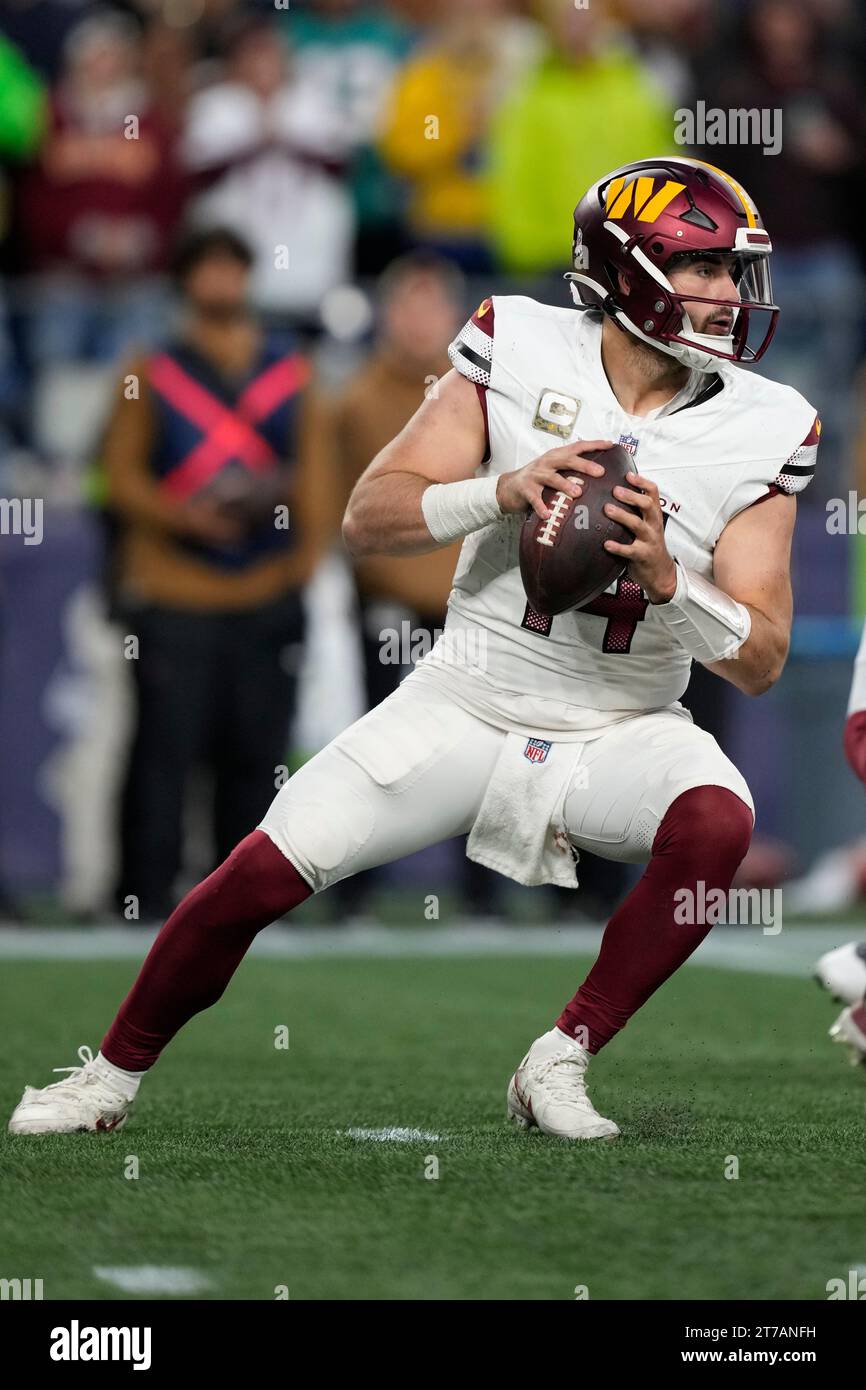 Washington Commanders quarterback Sam Howell (14) looks to pass the ...