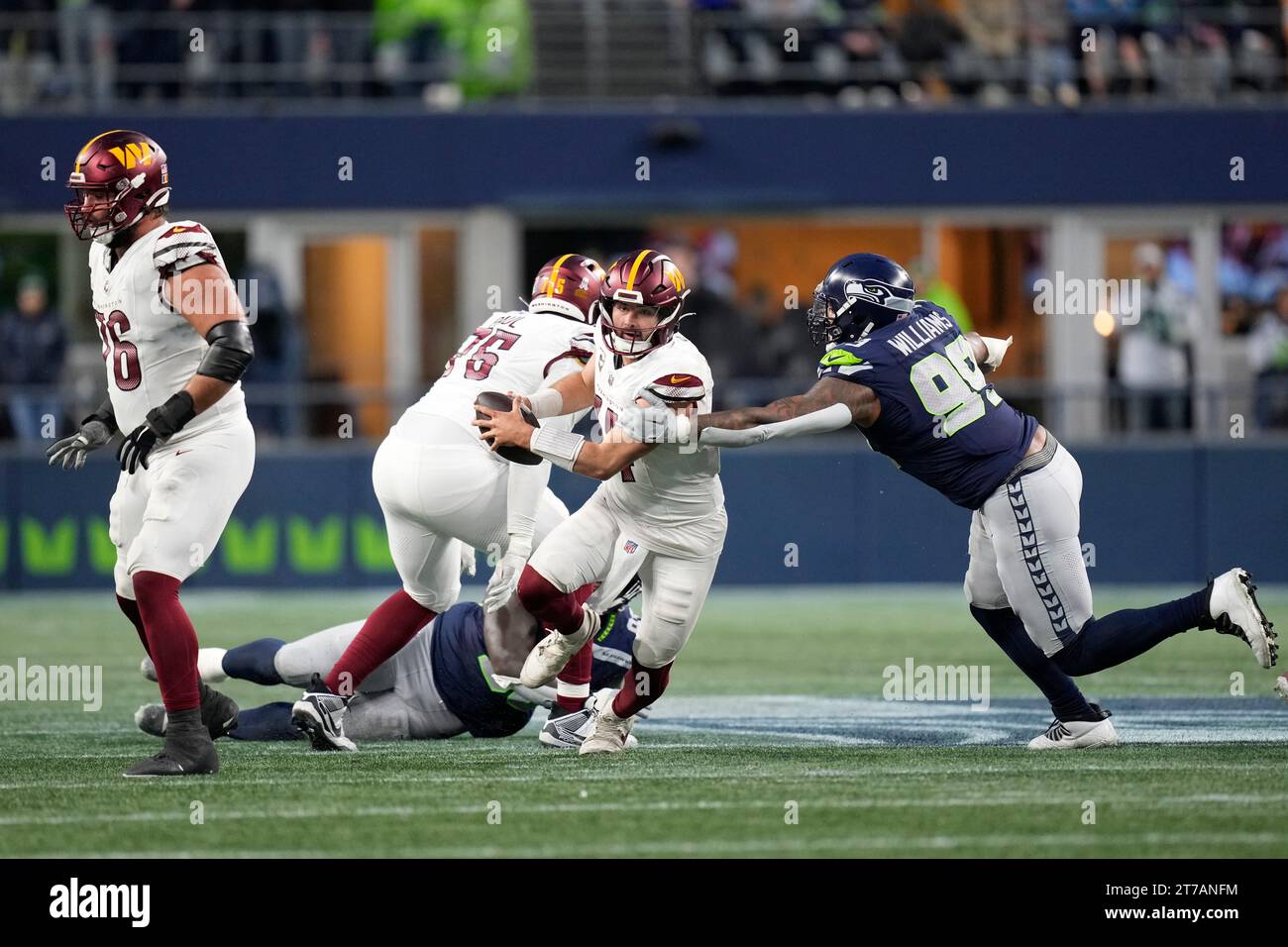 Washington Commanders quarterback Sam Howell (14) runs with the ball ...