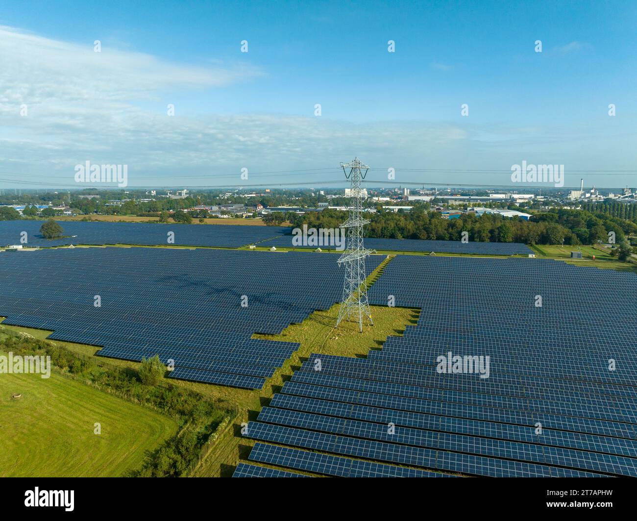 electricity pylons in the middle of a huge solar park Stock Photo - Alamy