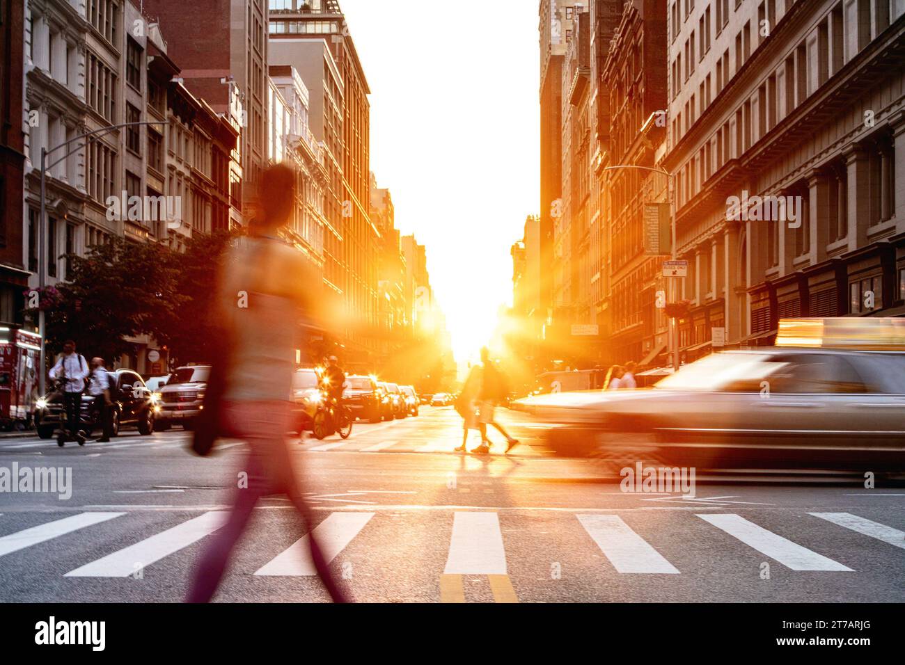 Person in motion walking through the busy intersection on 5th Avenue ...