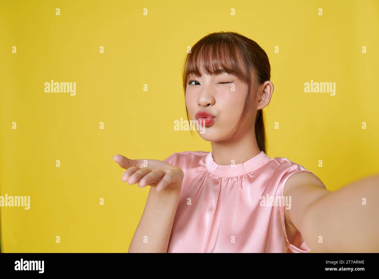 Lovable Asian Woman Standing With Kissing Face Expression Making