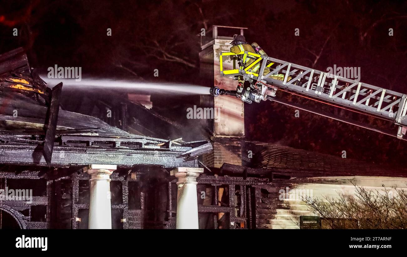 A firefighter works to spray water onto a blaze as nearly 200 years of ...