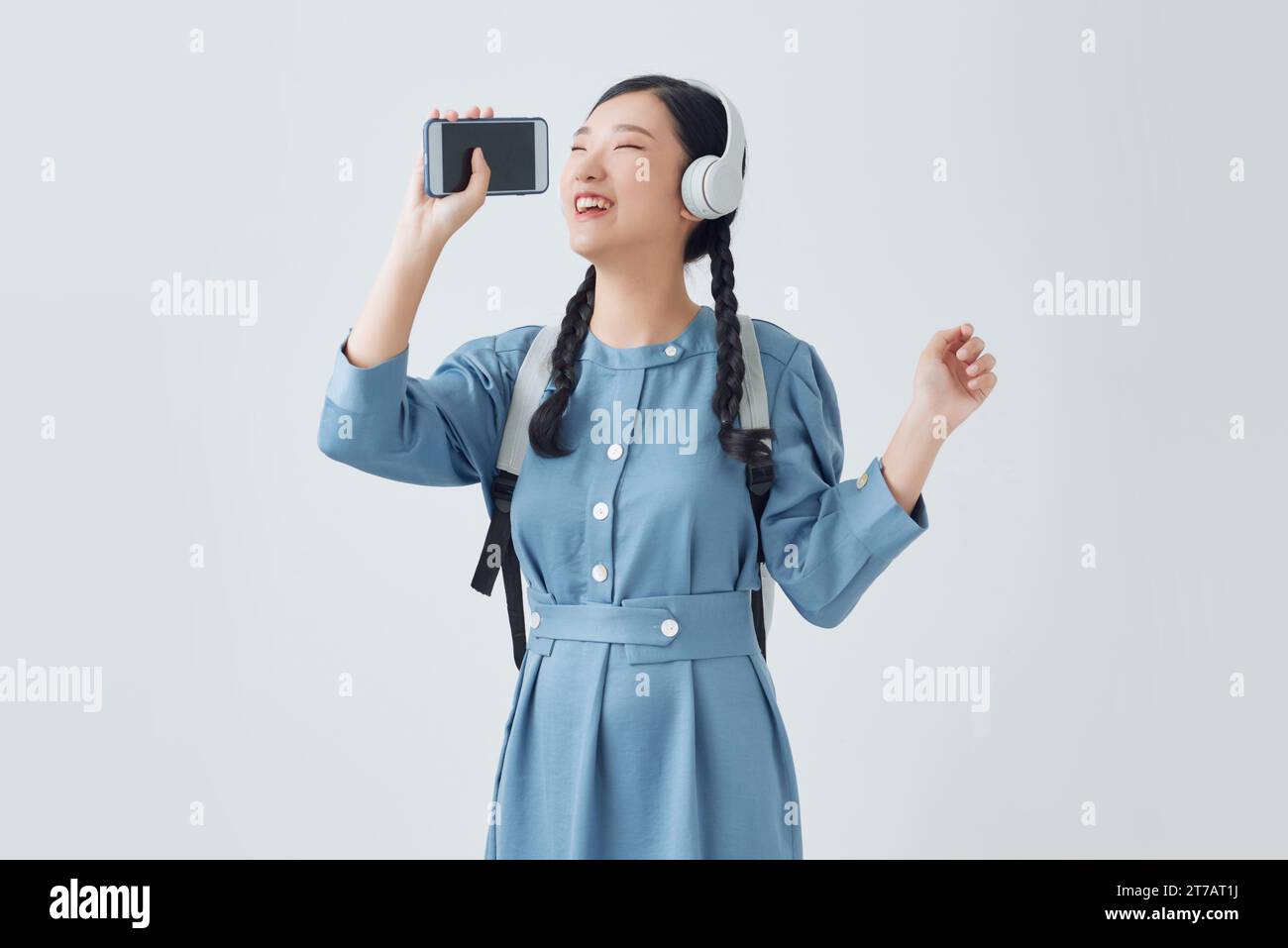 Excited emotional asian woman singing her favorite song, using ...