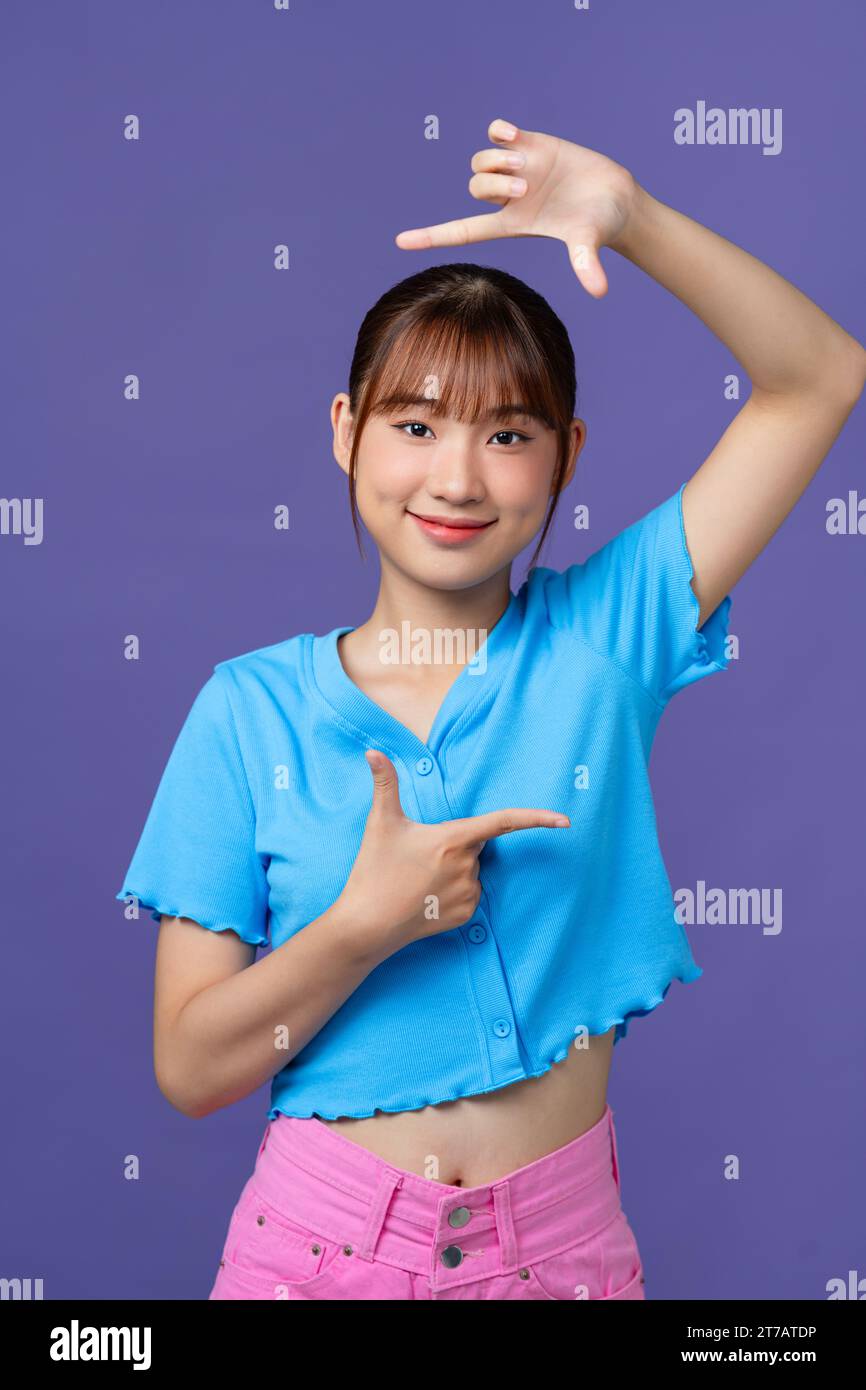 Young beautiful girl smiling making frame with hands and fingers with ...