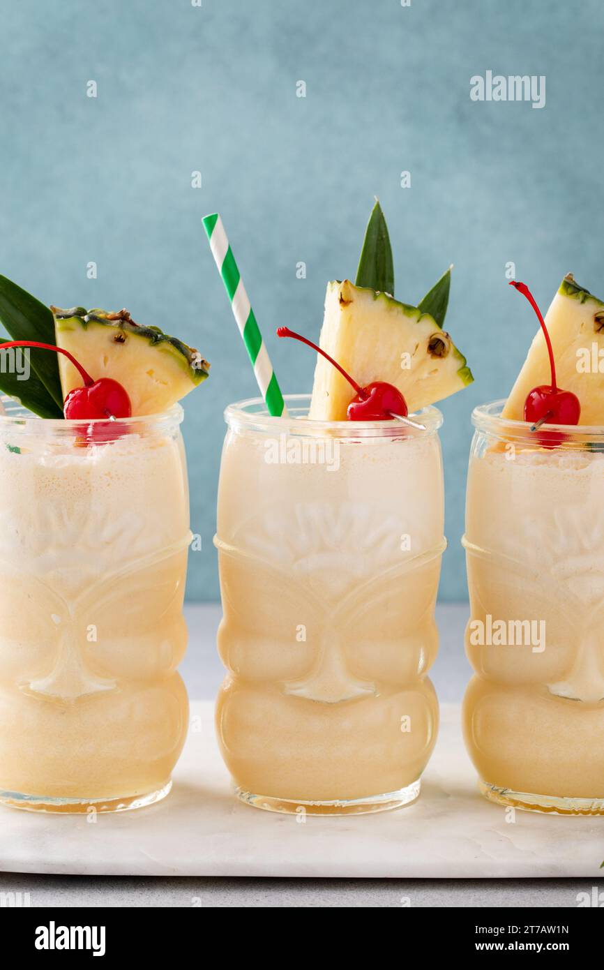 Pina colada in a tiki glass, tropical tiki cocktail with coconut, rum ...