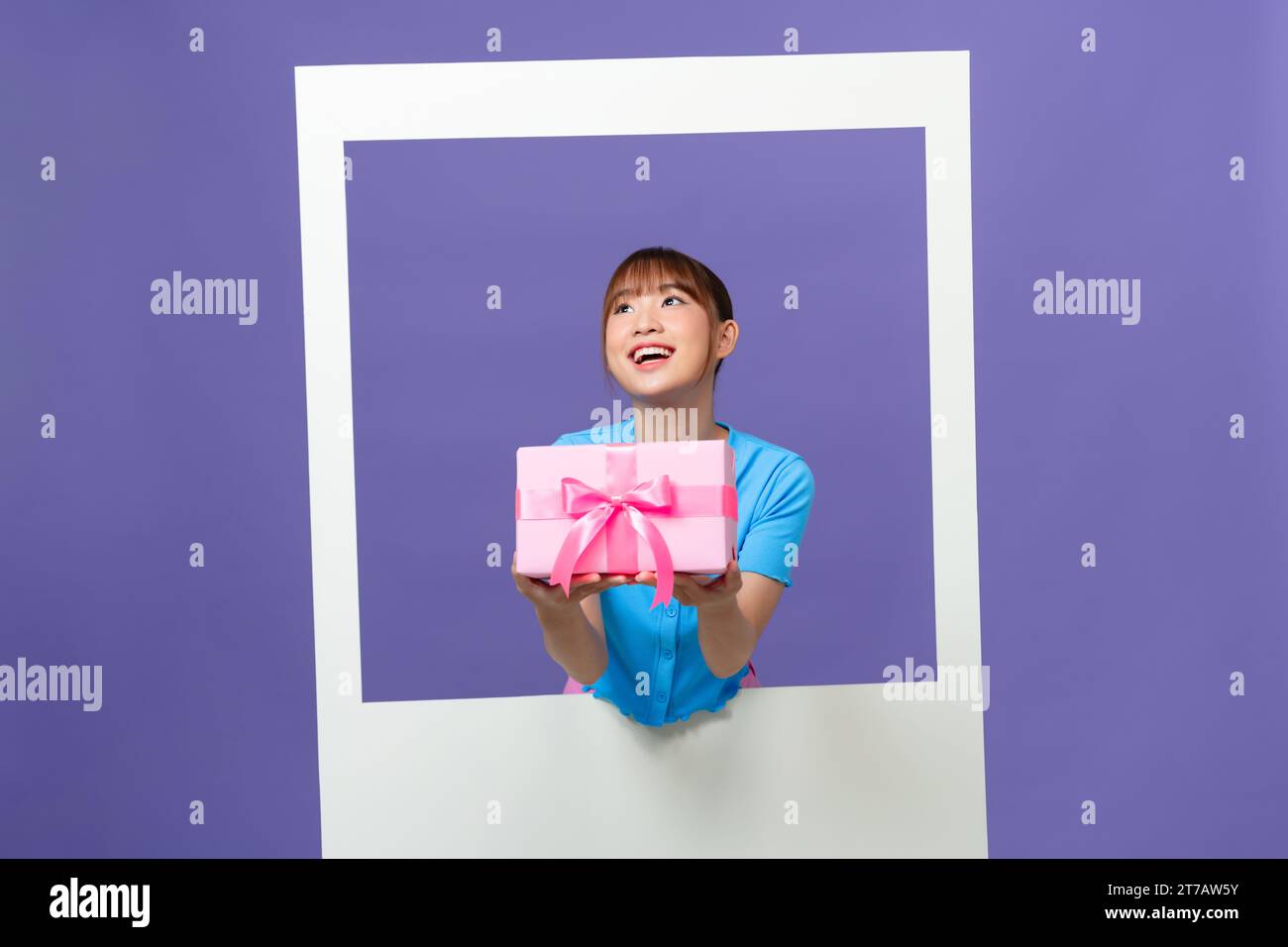 Excited young woman inside white photo frame over color background with ...