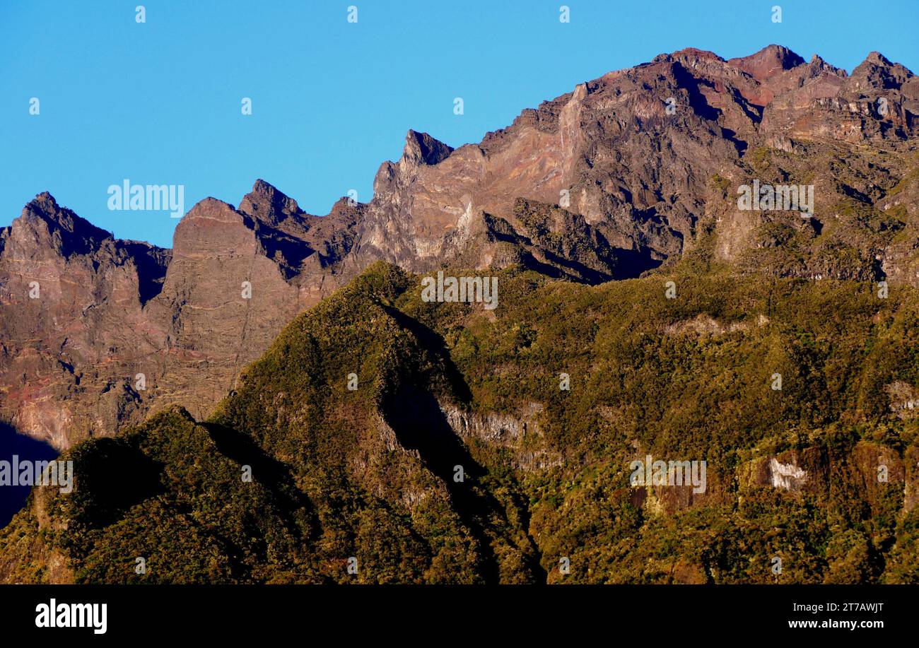 The sunset on a clear day over the Piton des Neiges seen from Cilaos ...
