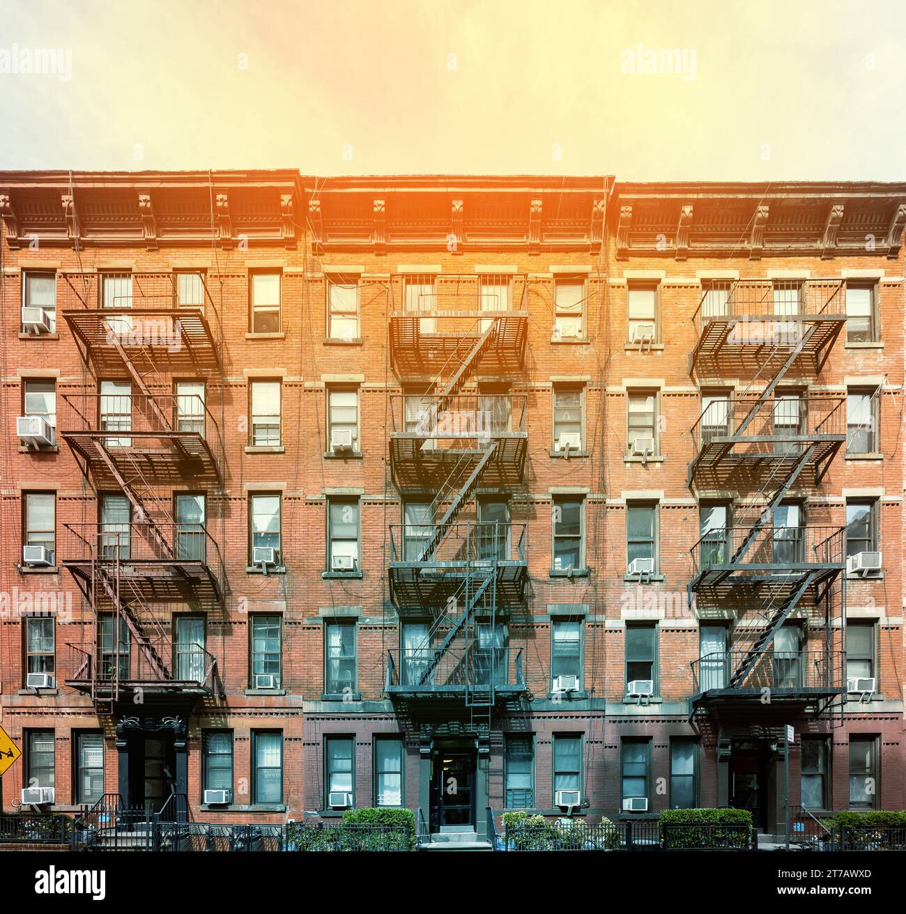 Block of classic old brick apartment buildings with windows and fire ...