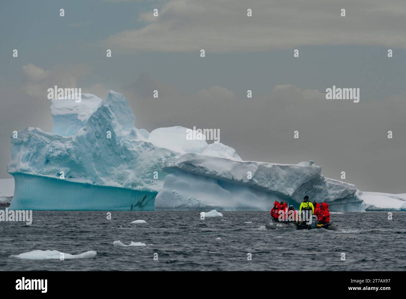 Tourists in an inflatable boat exploring Pleneau Island, Antarctica ...