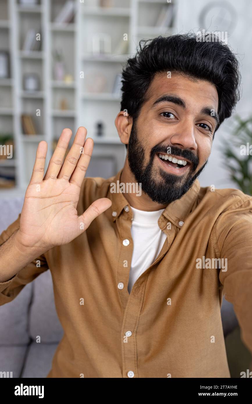 Happy Hindu man talking on video call on the phone, greeting waving to ...