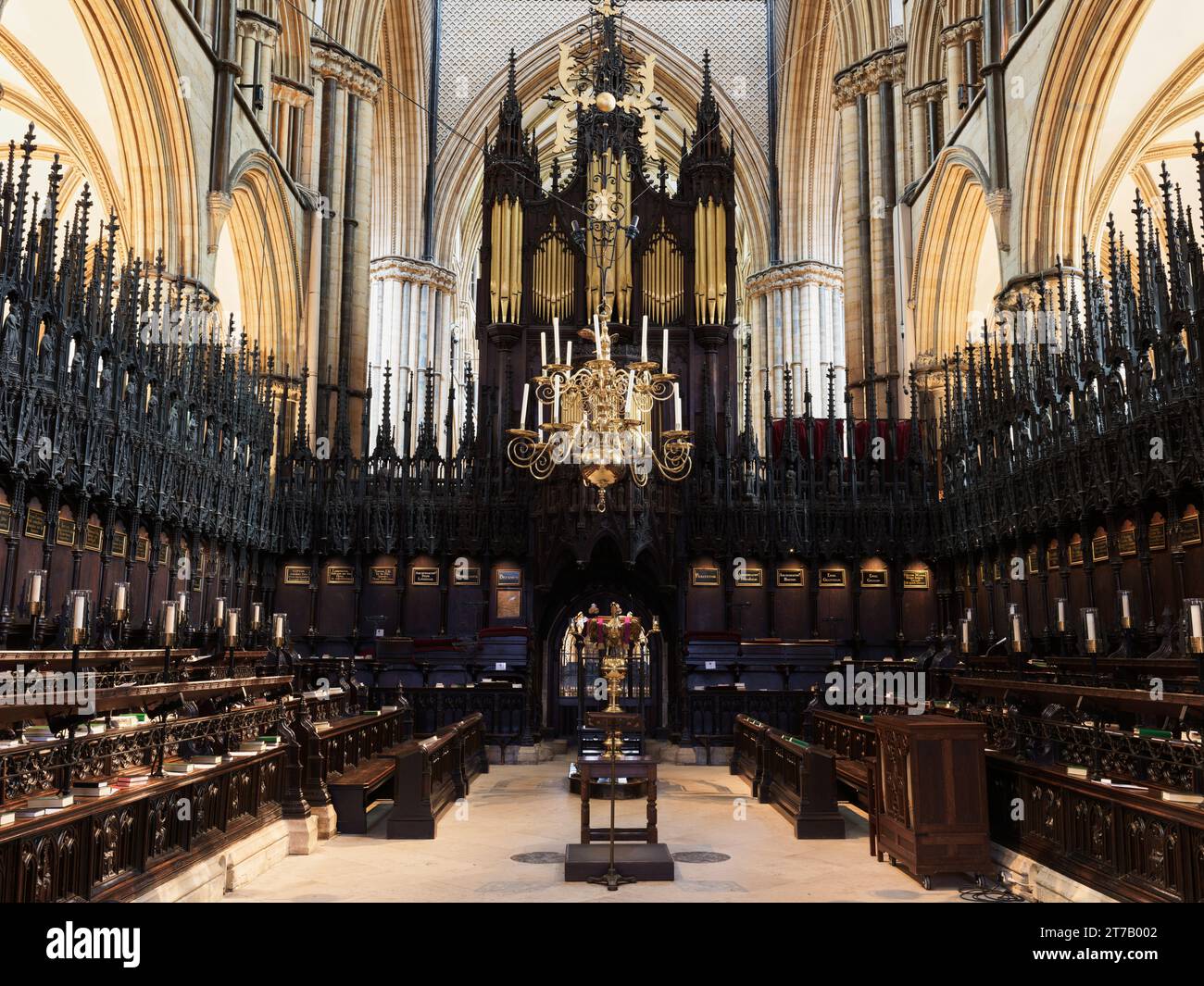The organ pipes and wooden benches in the choir (quire) in the medieval ...