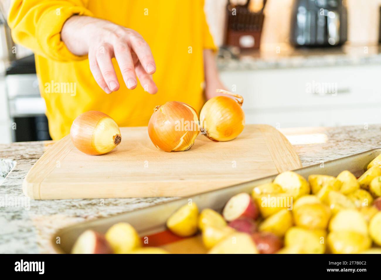 Slicing Yellow Onion for Grilling on Gas Grill Stock Photo - Alamy