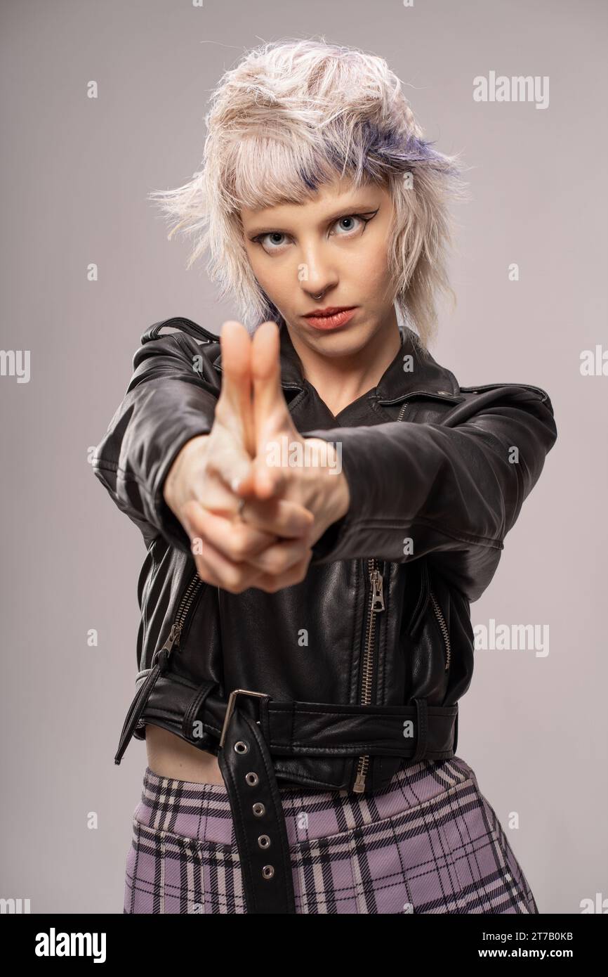 Young adult showcasing an edgy punk fashion style with a confident pose ...