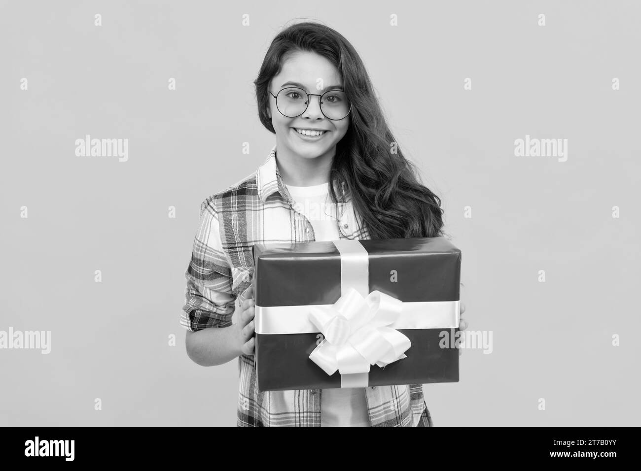 happy teen girl with present isolated on yellow background. teen girl ...