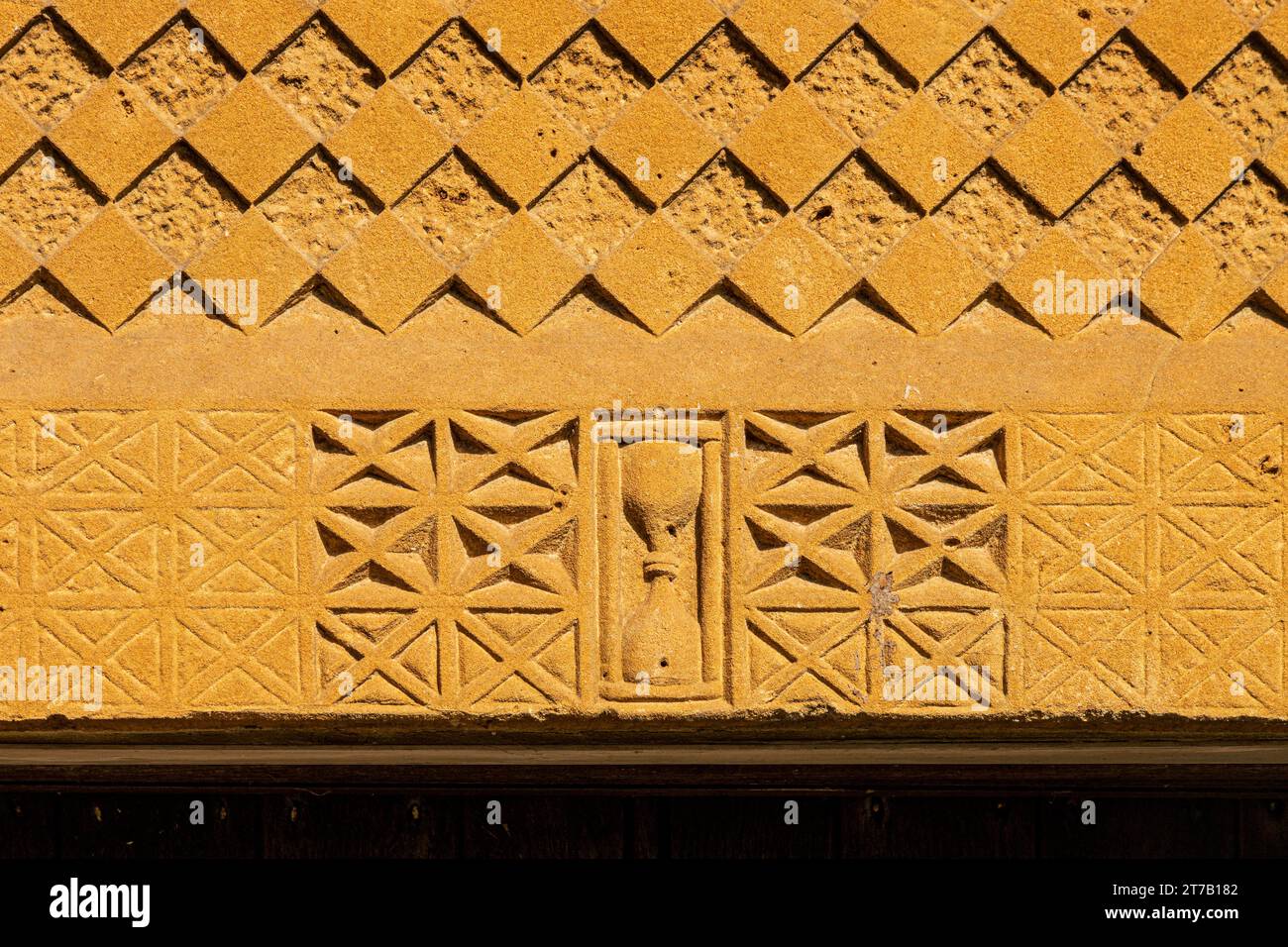 Hourglass motif over the south doorway on the Norman church of St ...