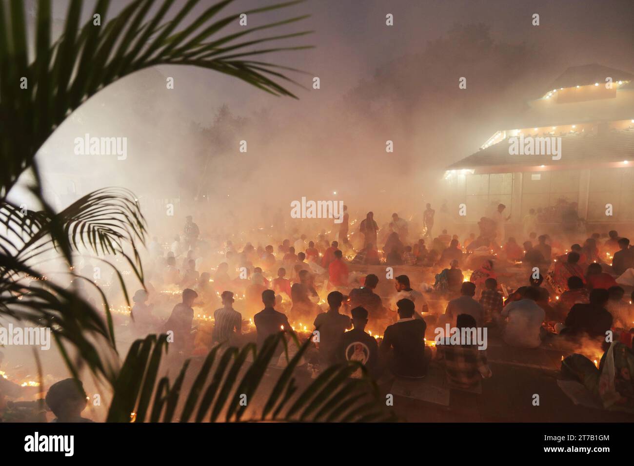 Hindu devotees sit together on the floor of Loknath Temple to observe ...