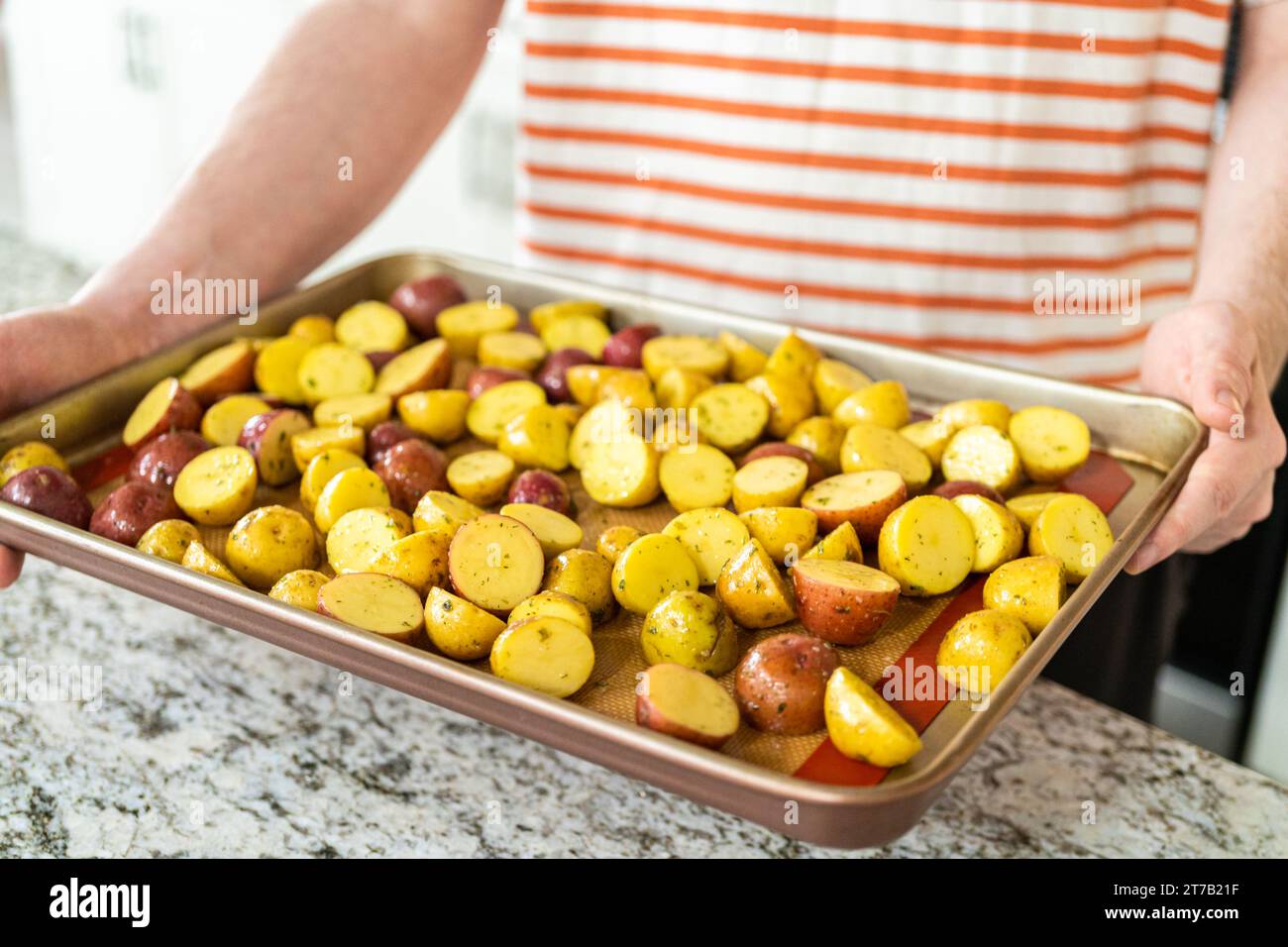 Roasting Halved Mixed Marble Potatoes in Modern Kitchen Stock Photo - Alamy