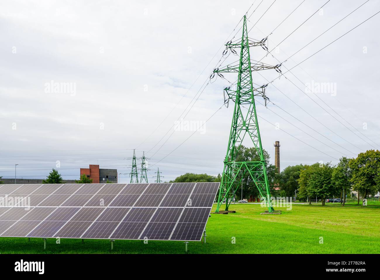 Solar panels power plant on metal frames in a green meadow near high ...