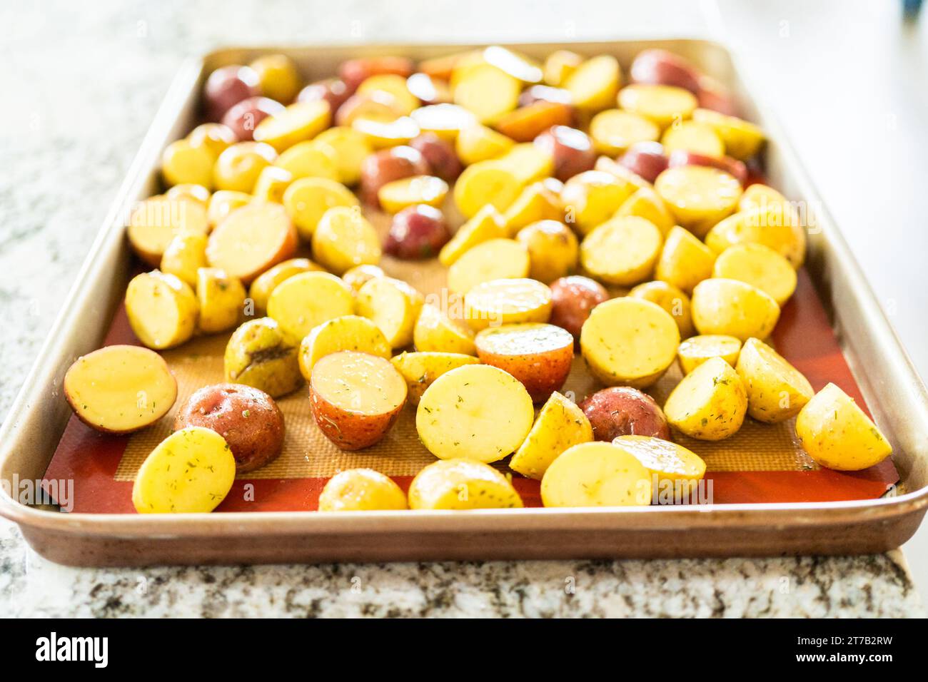 Roasting Halved Mixed Marble Potatoes in Modern Kitchen Stock Photo - Alamy