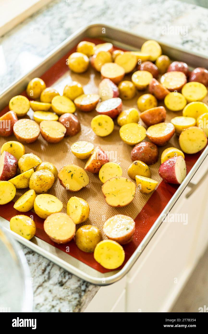 Roasting Halved Mixed Marble Potatoes in Modern Kitchen Stock Photo - Alamy