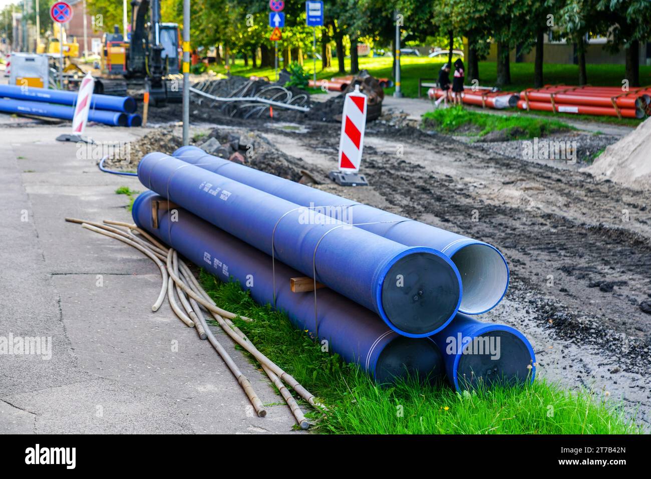New blue thick plastic underground water supply pipes near trench on ...