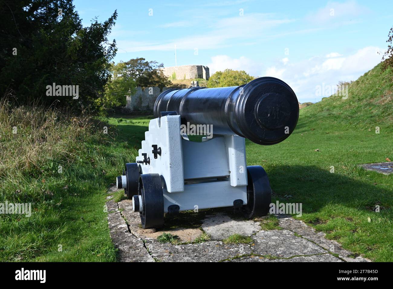 An antique cannon is proudly displayed in a public park in front of a ...