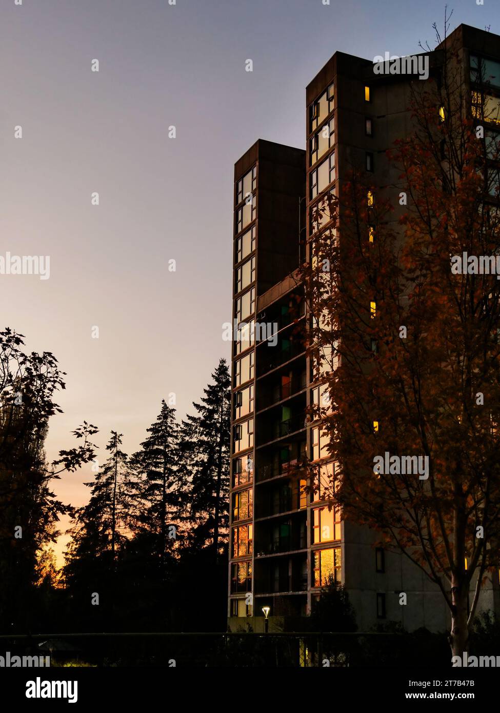 Sunset in a city. High-rise residential building on sunset sky ...