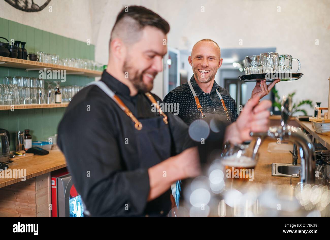 Two men friends barman and waiter with tray dressed black uniform at ...
