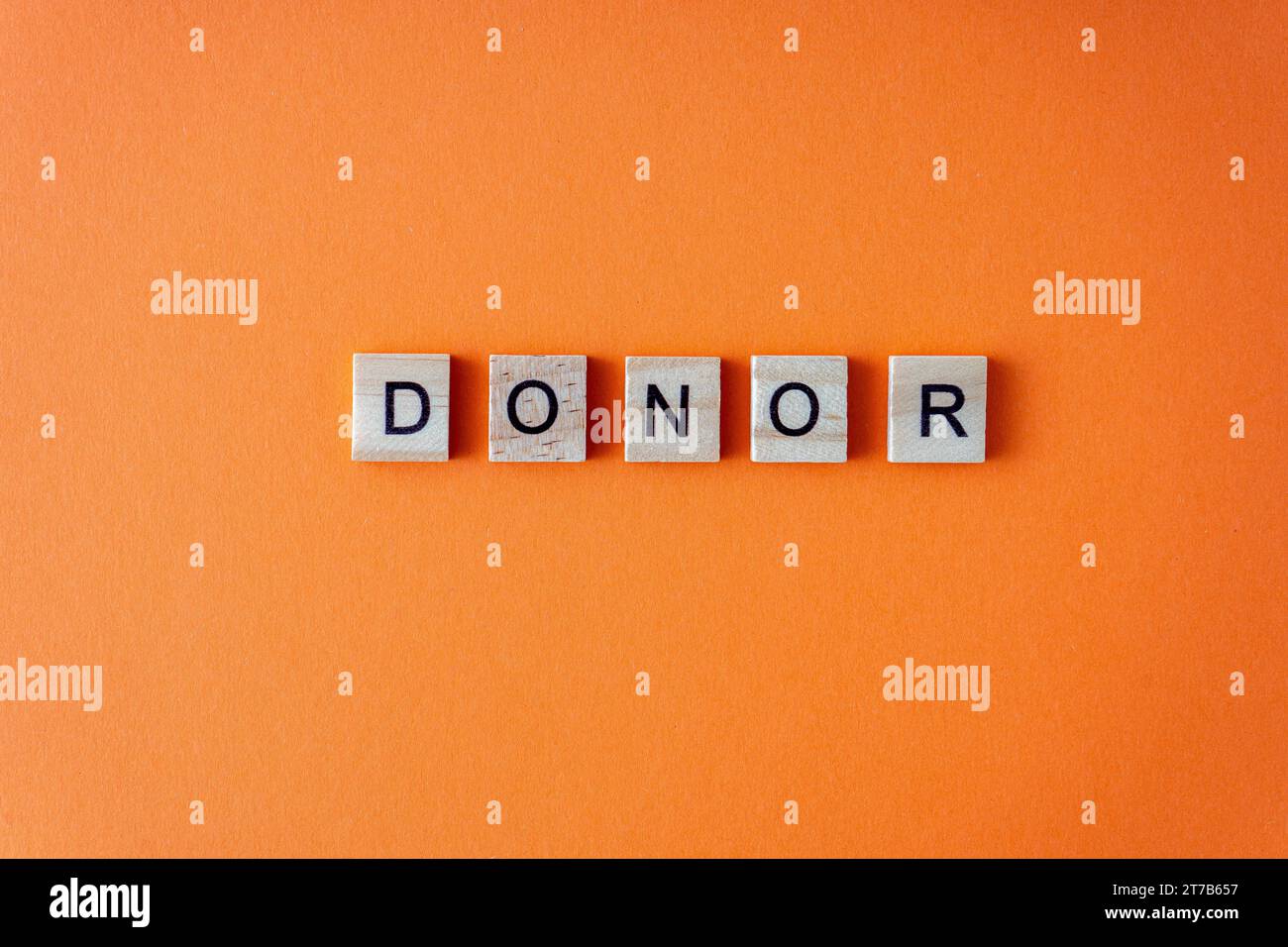 Word donor. The phrase is laid out in wooden letters top view ...