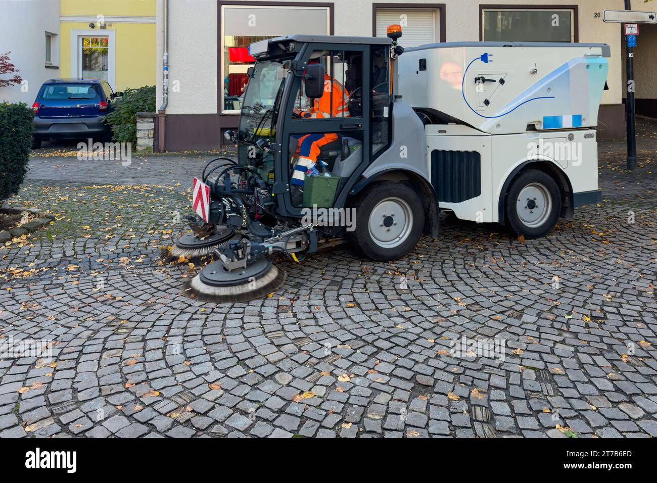 A street sweeper machine cleaning the paved sidewalks. City street ...
