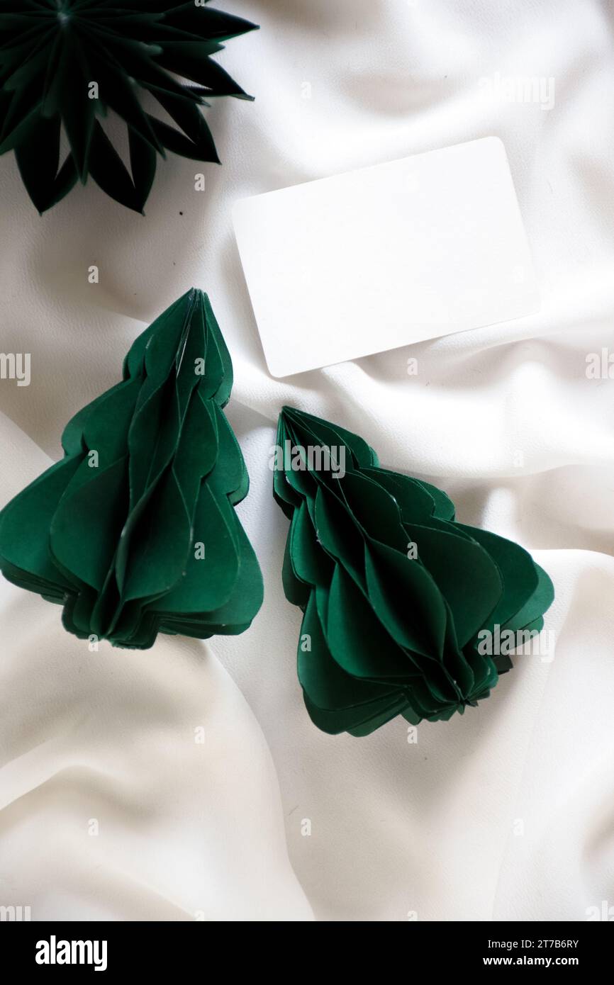 Two pieces of white paper are set side by side against a background of ...