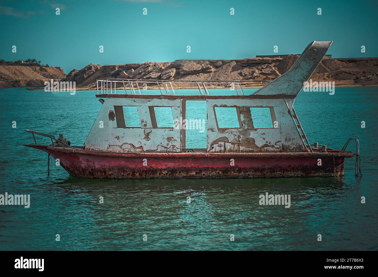 Old rusty boat is destroyed in shallows in bay Stock Photo - Alamy