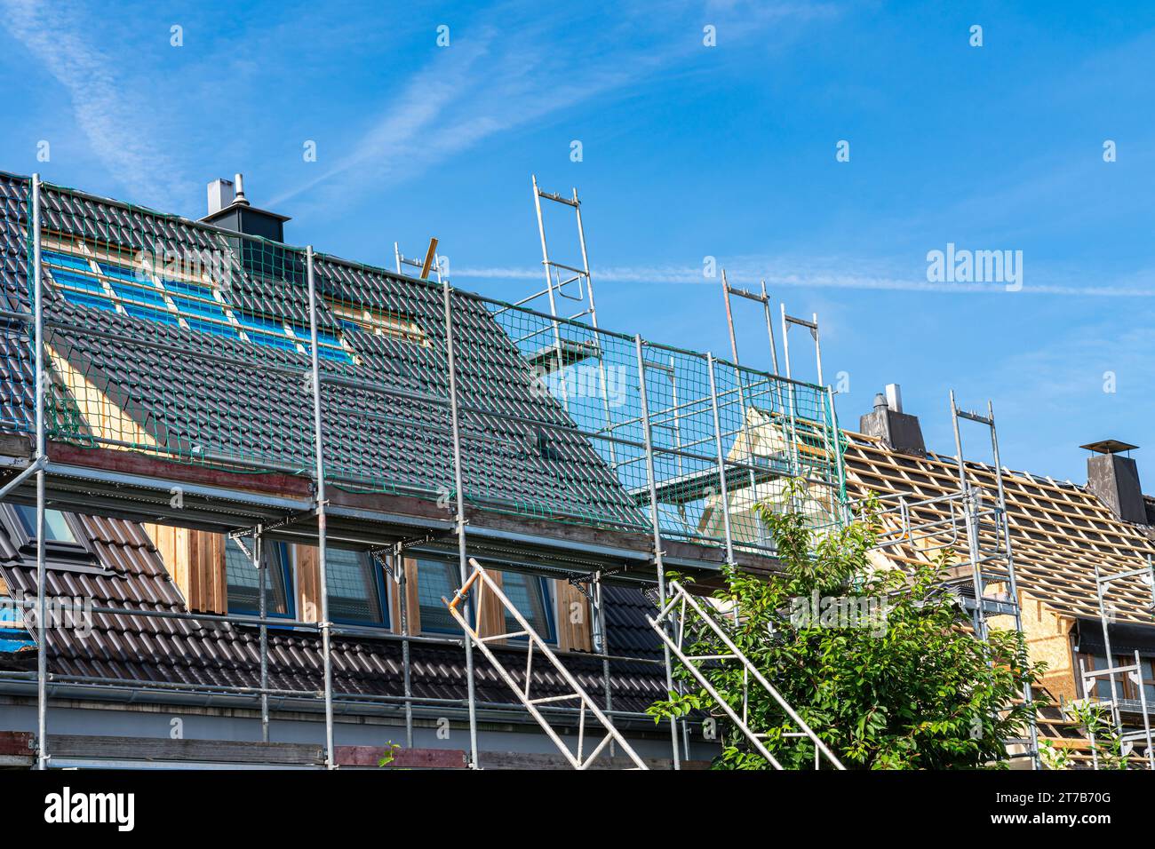 Residential buildings on which a new roof is being re-roofed are ...